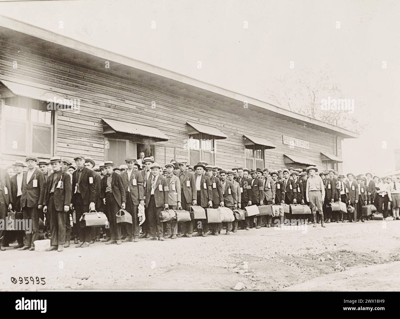 American men standing in line at a cantonement after being drafted into ...