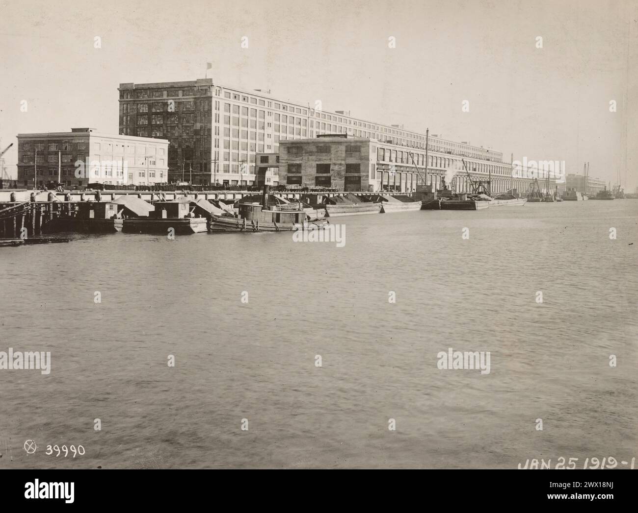 Army warehouse in Port Newark New Jersey, tugboat in the foreground ca. 1918-1922 Stock Photo ...