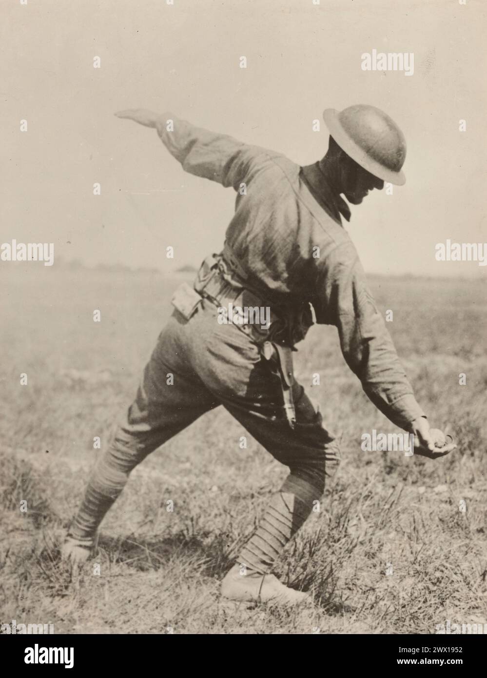A soldier illustrating the proper method of throw hand grenades ca ...