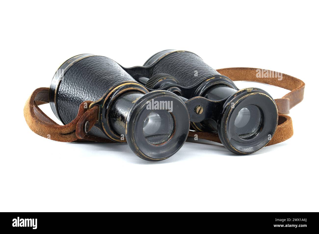 Ancient pair of black binoculars with brown leather straps isolated on ...