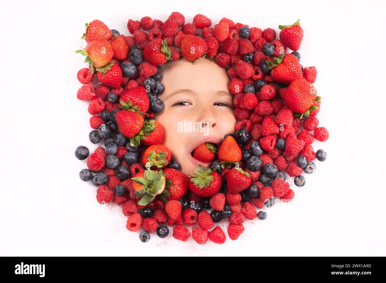 Summer fruits. Berries child face close up. Top view photo of child ...