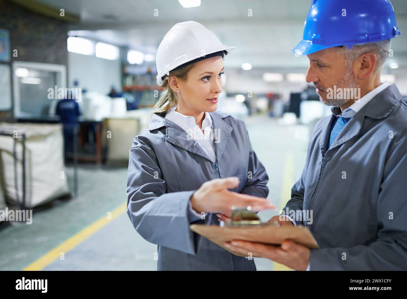 Man, woman and conversation with clipboard in warehouse for quality ...