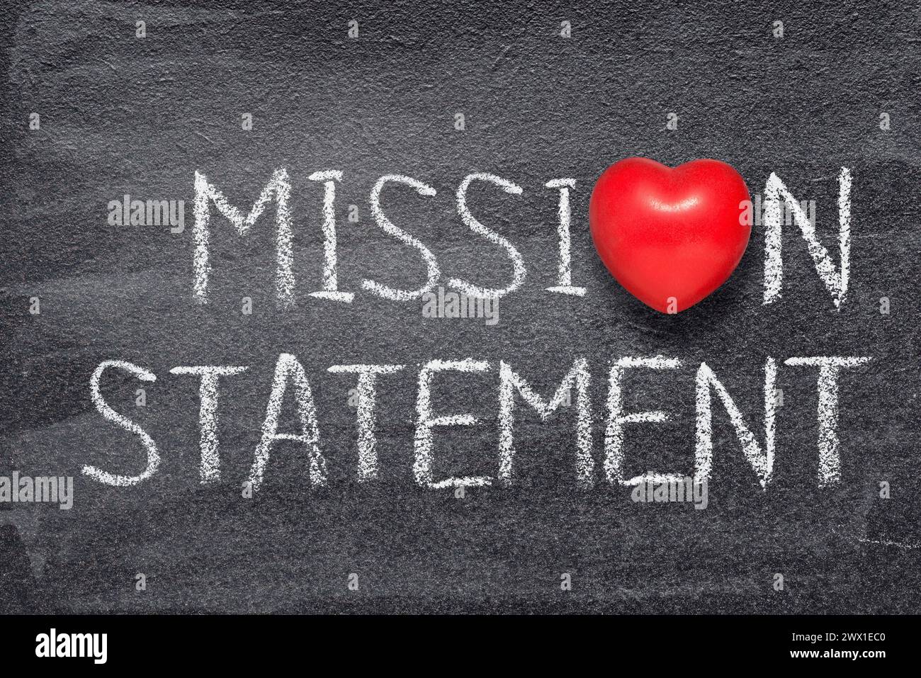 mission statement phrase written on chalkboard with red heart symbol ...