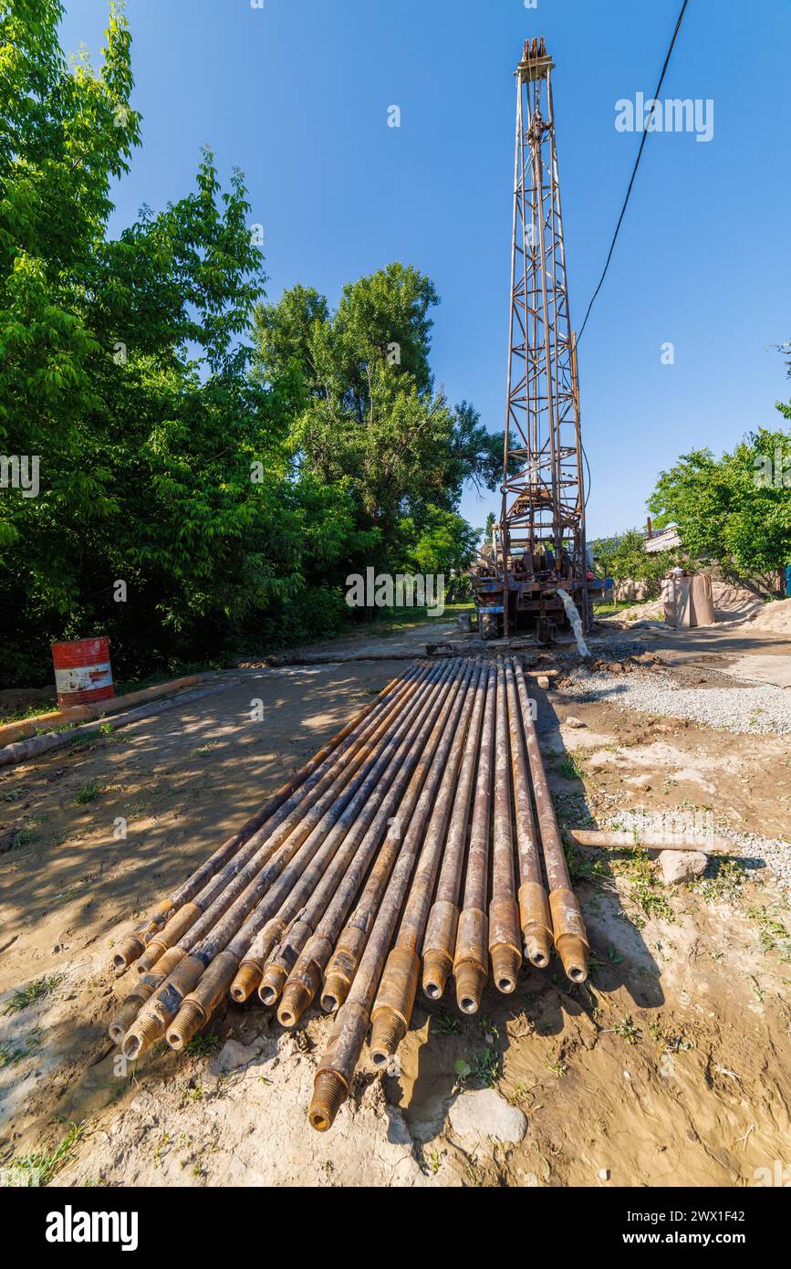 extension drilling rods in front of old water pump truck that extracts ...