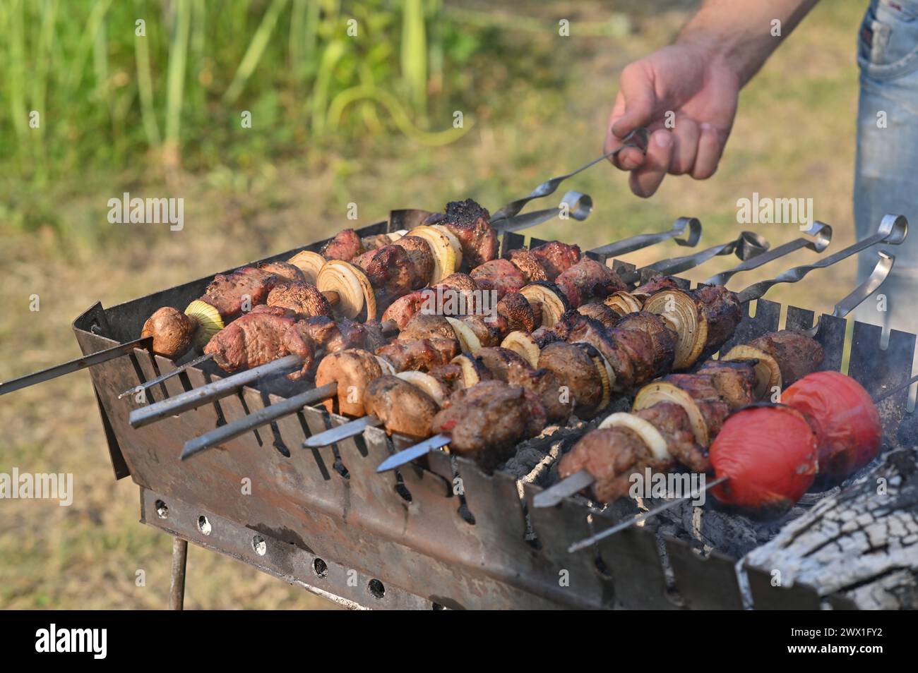 Juicy meat skewers grilling over hi-res stock photography and images - Alamy
