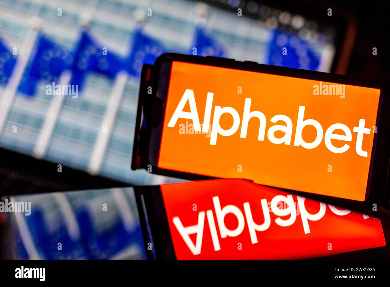 In this photo illustration logo of Alphabet is seen on a smartphone and ...