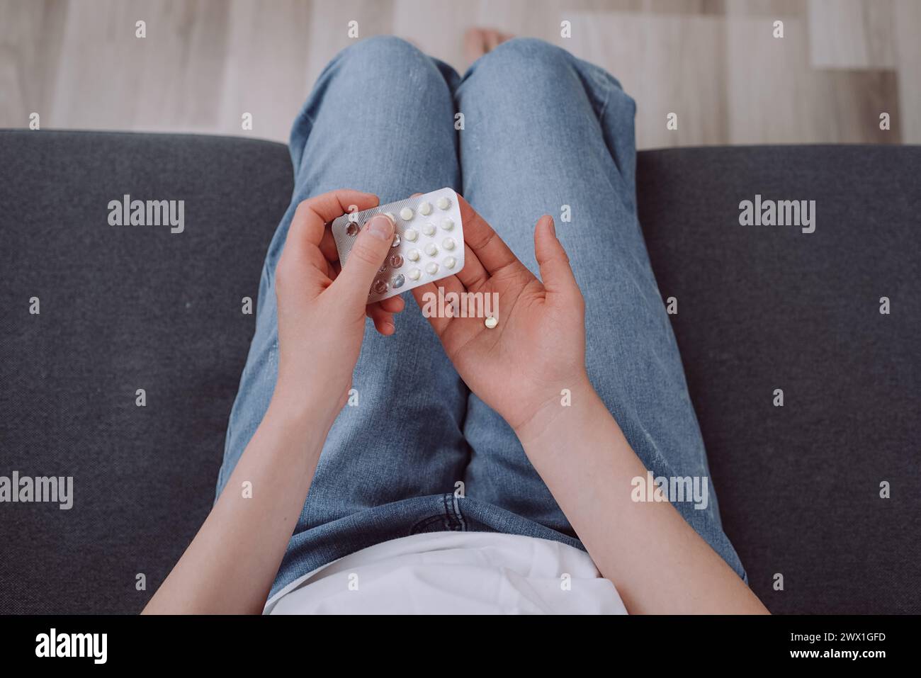 Selective focus of young girl opening birth control pills, holding ...
