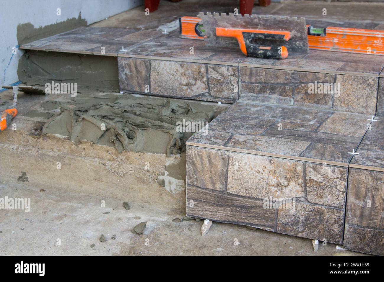 a new ceramic tile to lay on the stairs in the house, laying tiles on ...