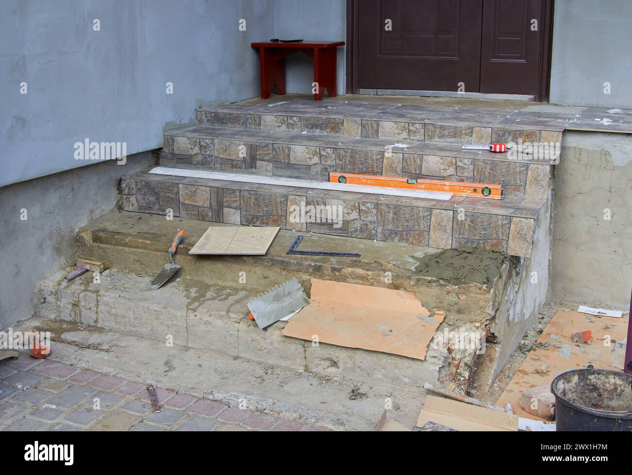 put on the stairs gray tiles, tools on the stairs Stock Photo - Alamy