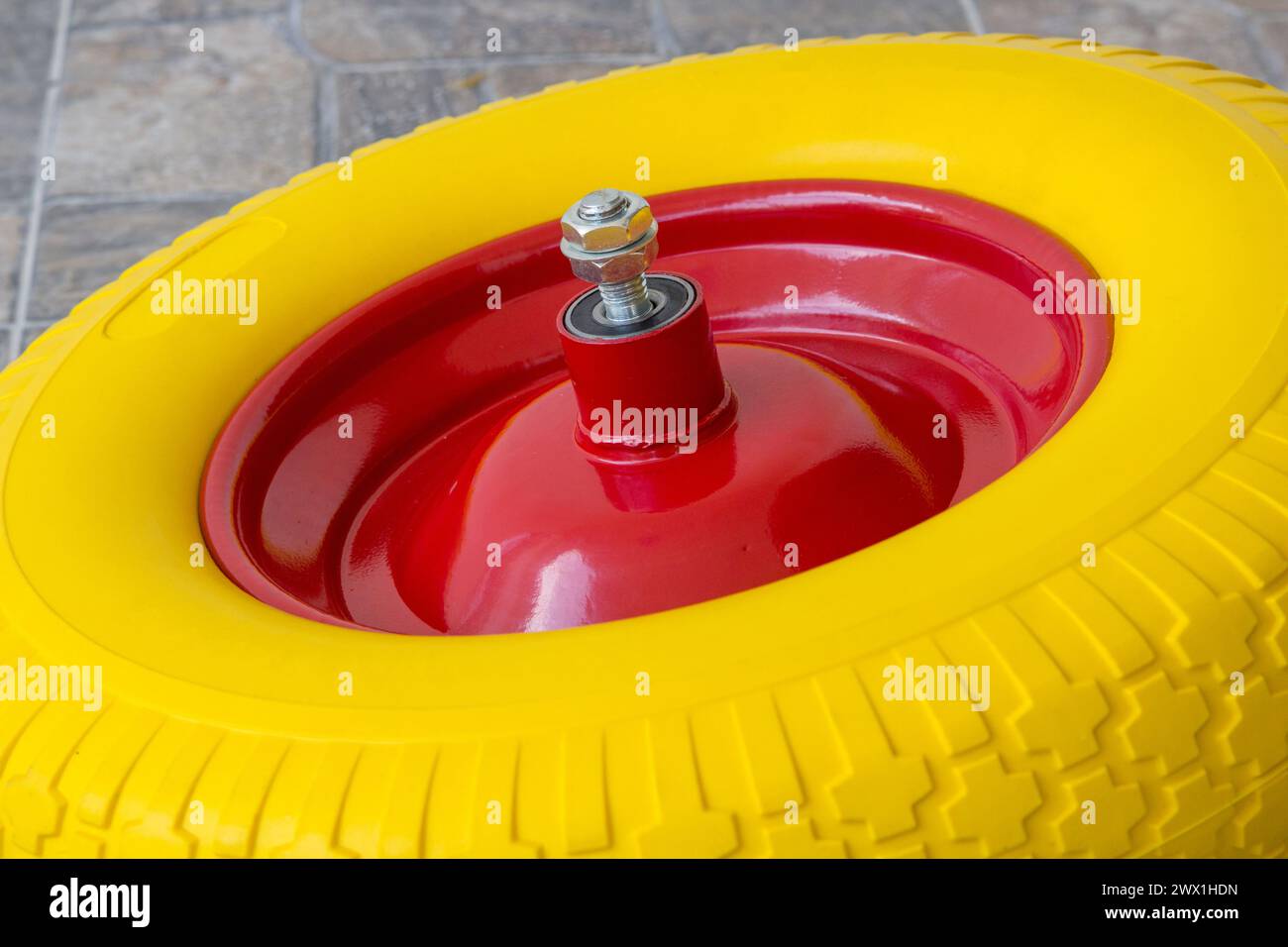 new yellow wheel close-up for a garden wheelbarrow Stock Photo - Alamy