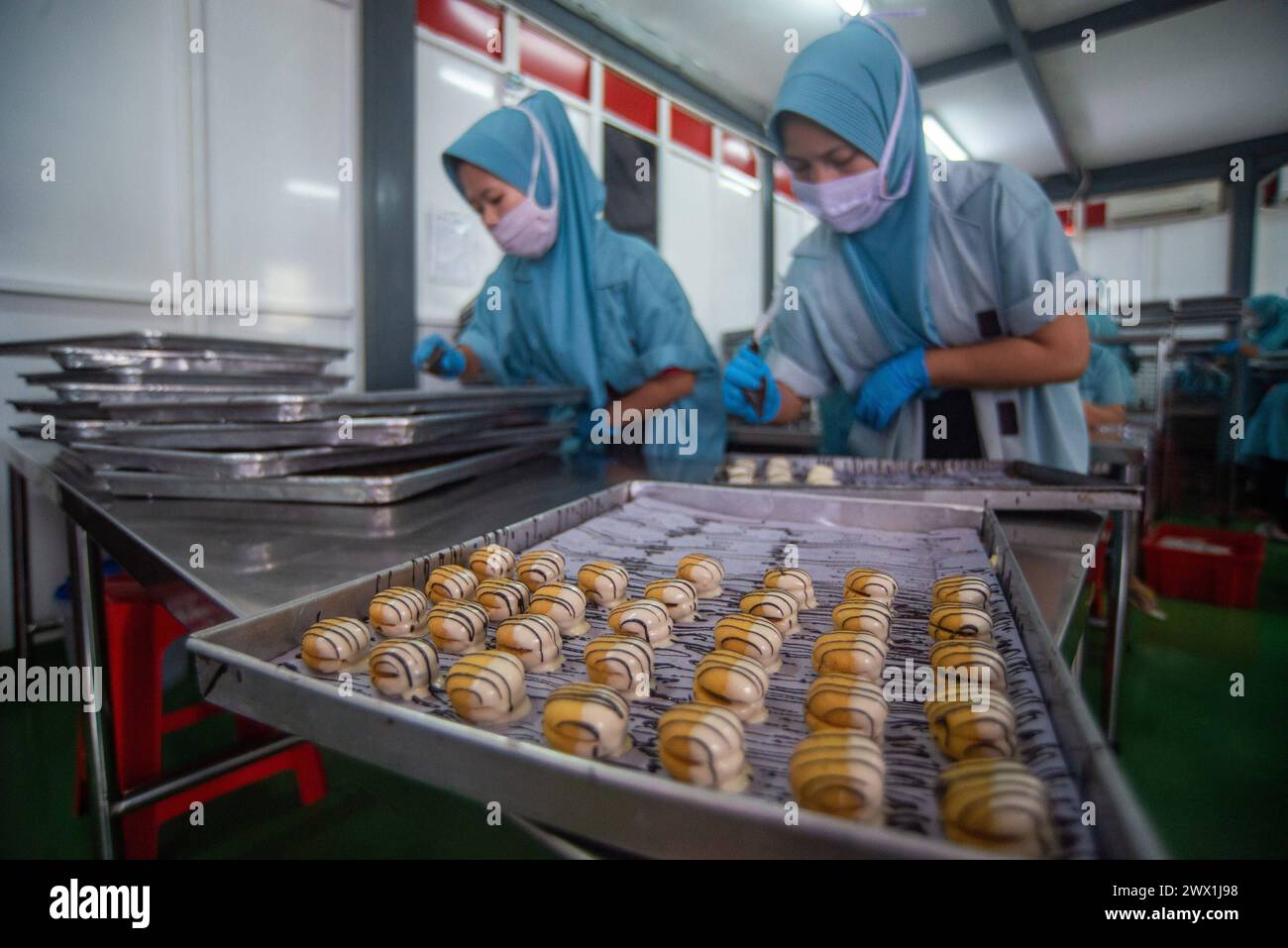 COOKIES PRODUCTION AHEAD OF EID Workers finish making cookies at the J ...