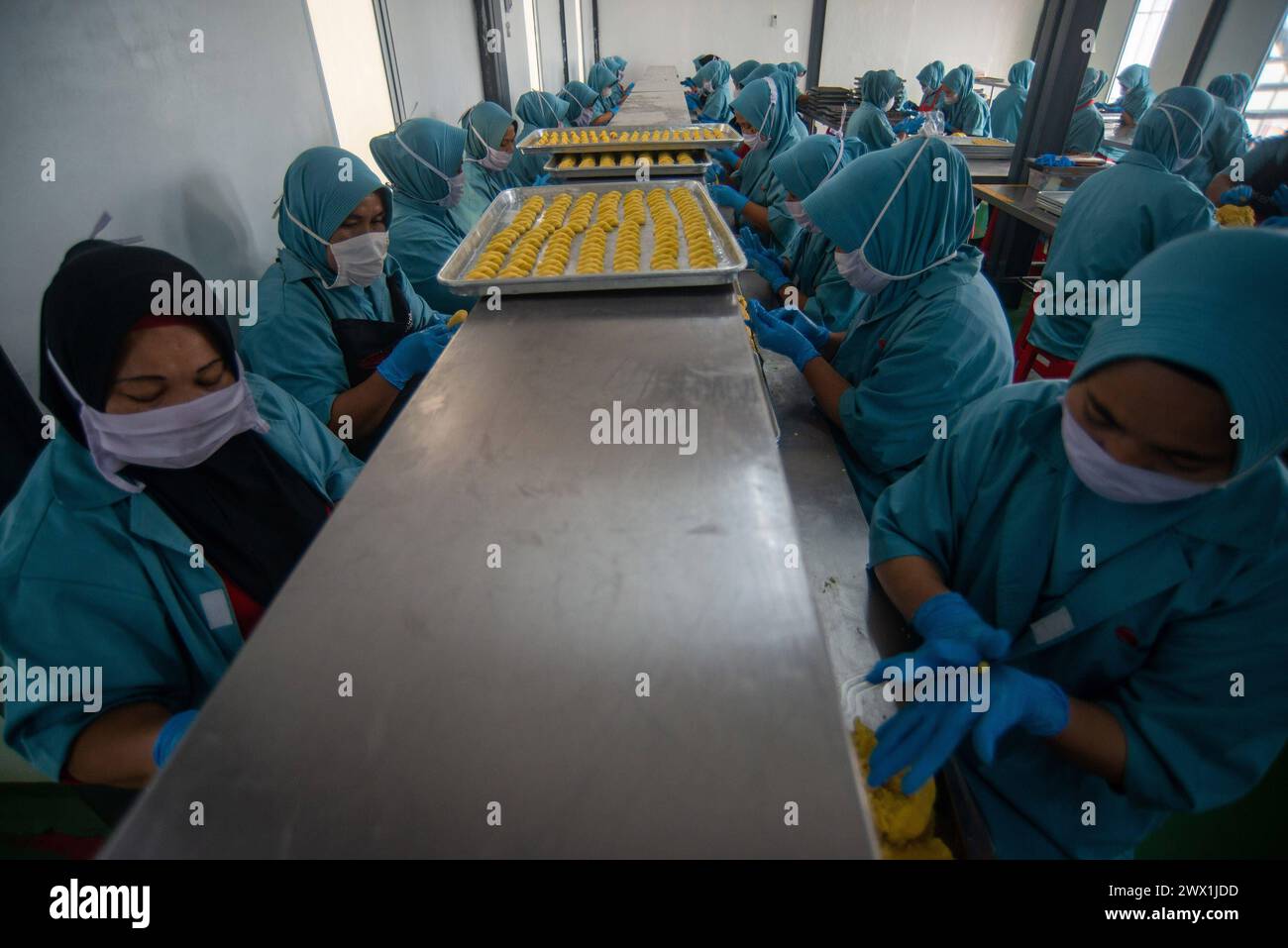 COOKIES PRODUCTION AHEAD OF EID Workers finish making cookies at the J ...