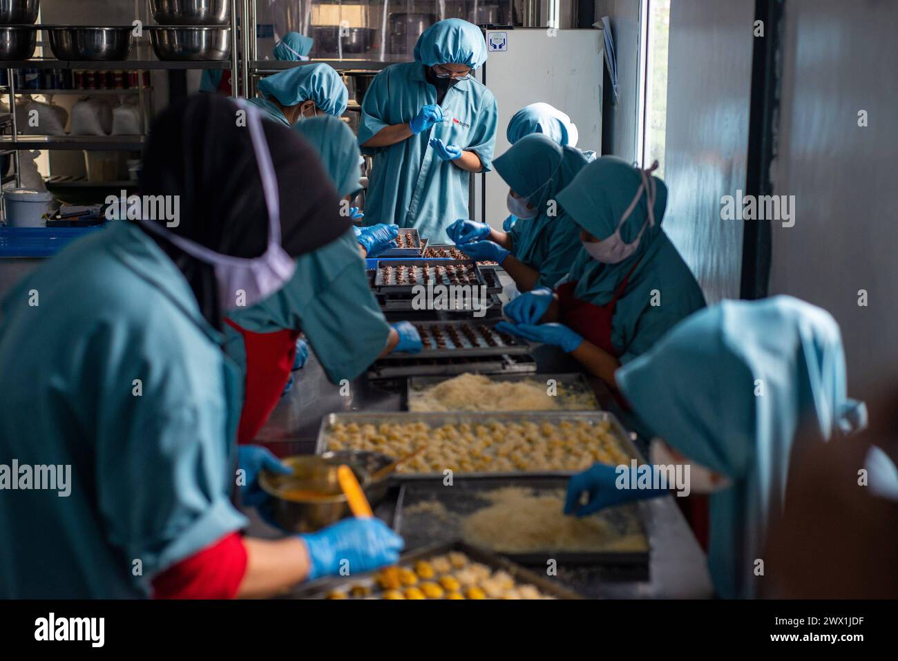 COOKIES PRODUCTION AHEAD OF EID Workers finish making cookies at the J ...
