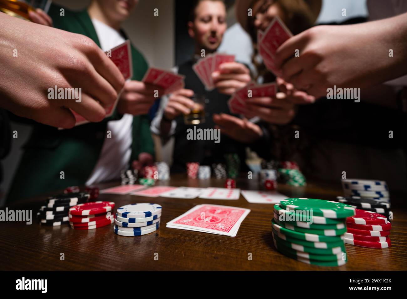 A team of young boys and girls play poker. First-person observation of ...