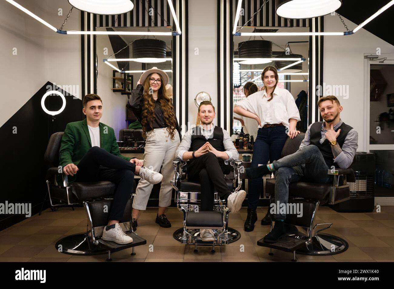Portrait of a professional barbershop team. Five hairdressers stylists ...