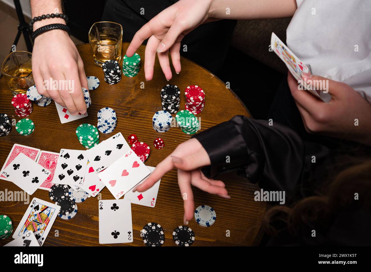 A team of young boys and girls play poker. First-person observation of ...
