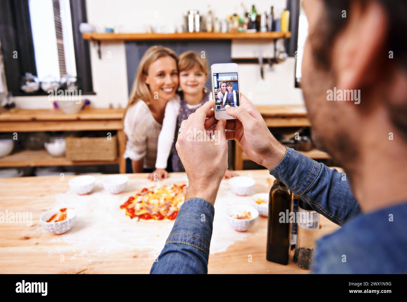 Happy family, phone and picture in kitchen for baking pizza together ...