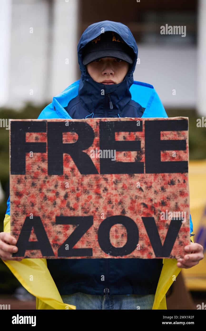 Patriotic Ukrainian boy posing with a sign "Free Azov" at a ...