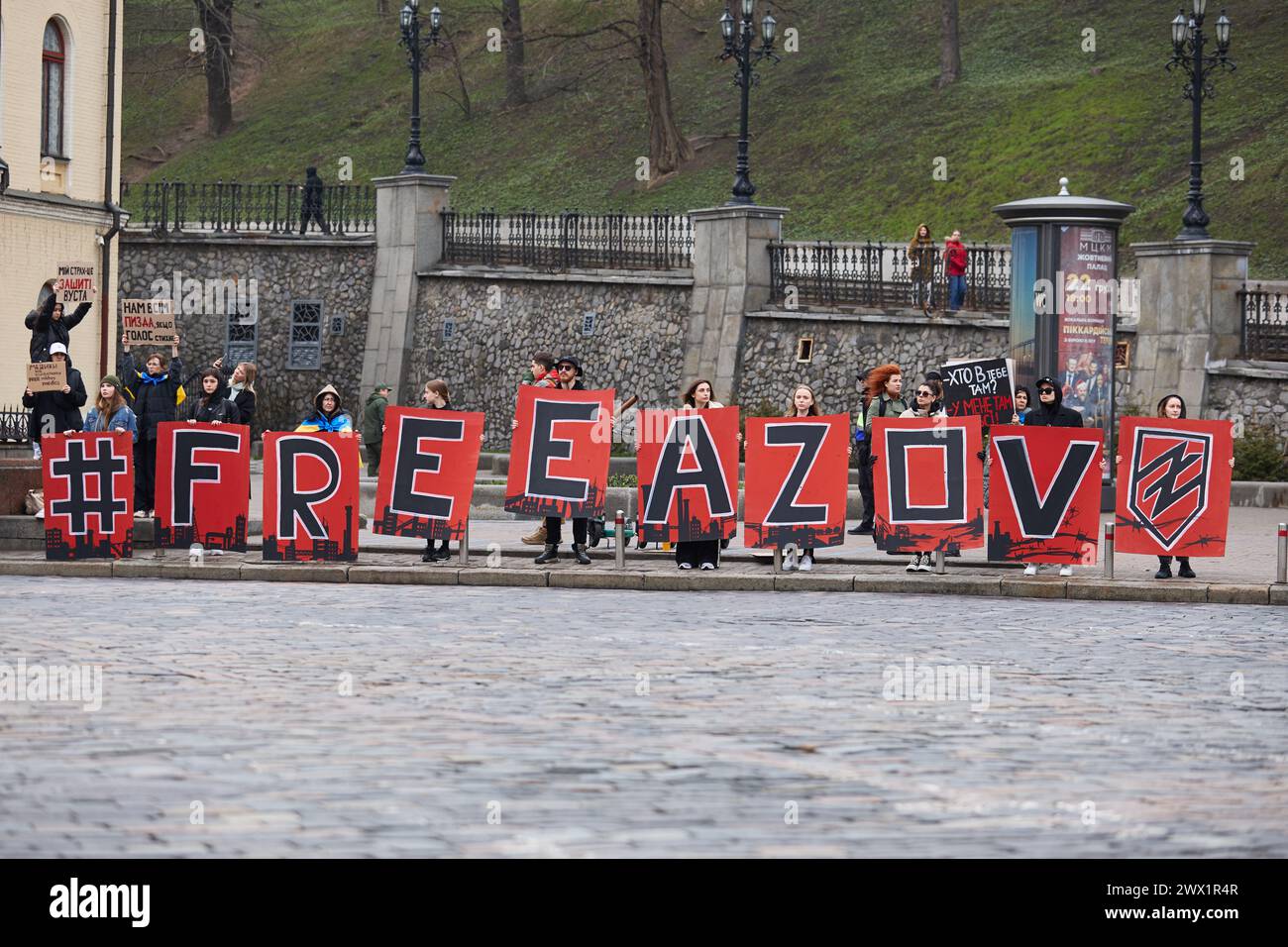 Group of Ukrainian activists hold banner "Free Azov" by the road road on a public demonstration ...