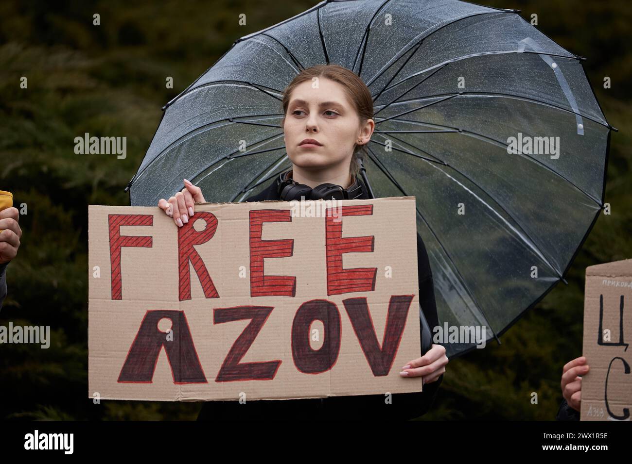 Ukrainian woman shows a sign "Free Azov" on a public rally for release ...