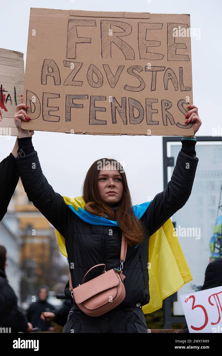 Young Ukrainian girl posing with a banner "Free Azovstal Defenders ...