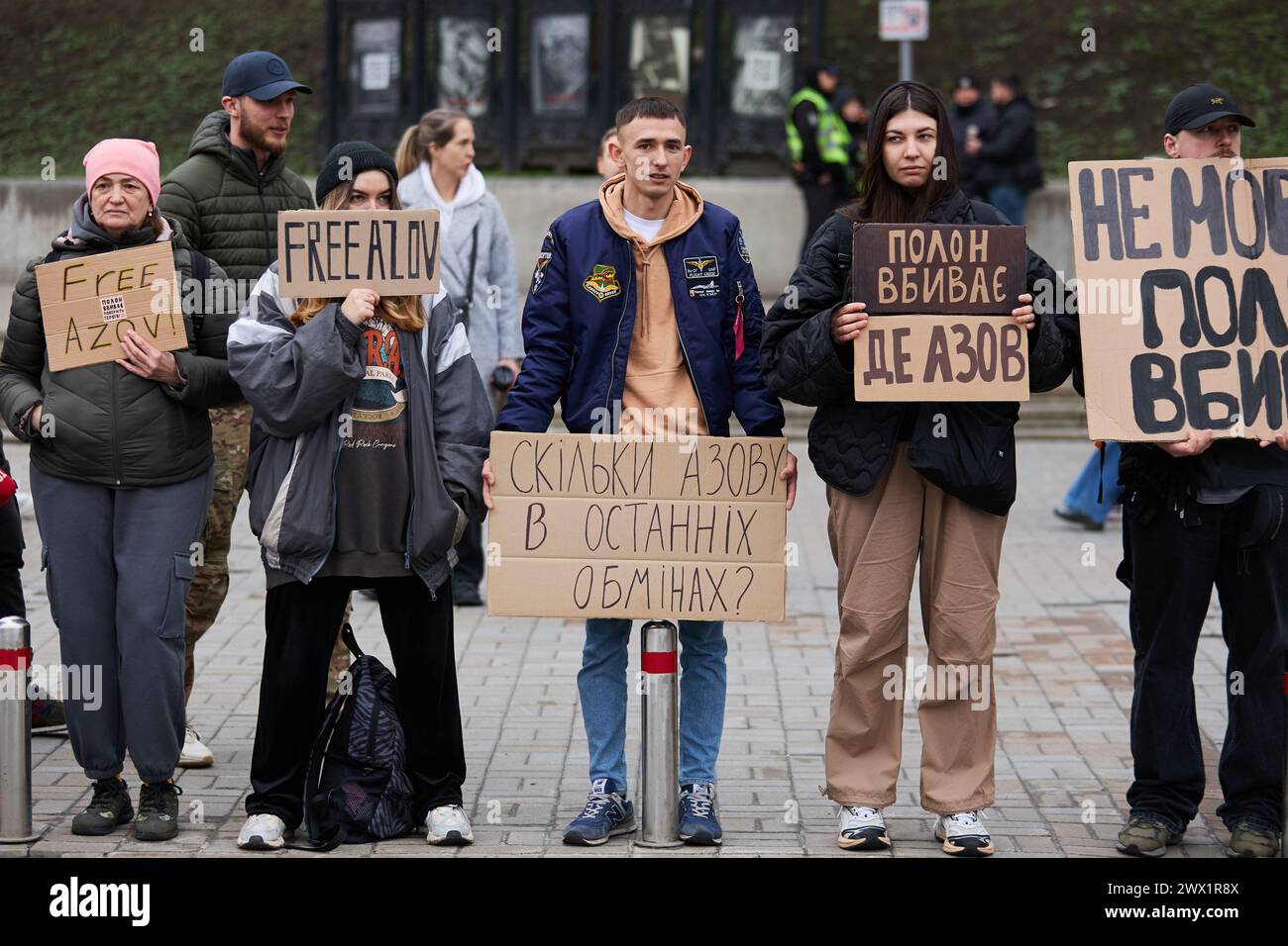Ukrainian activists posing with banners "Free Azov" and "Where Is Azov ...