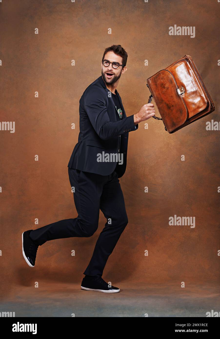 Briefcase, fashion and man in studio with glasses for trendy, edgy and ...