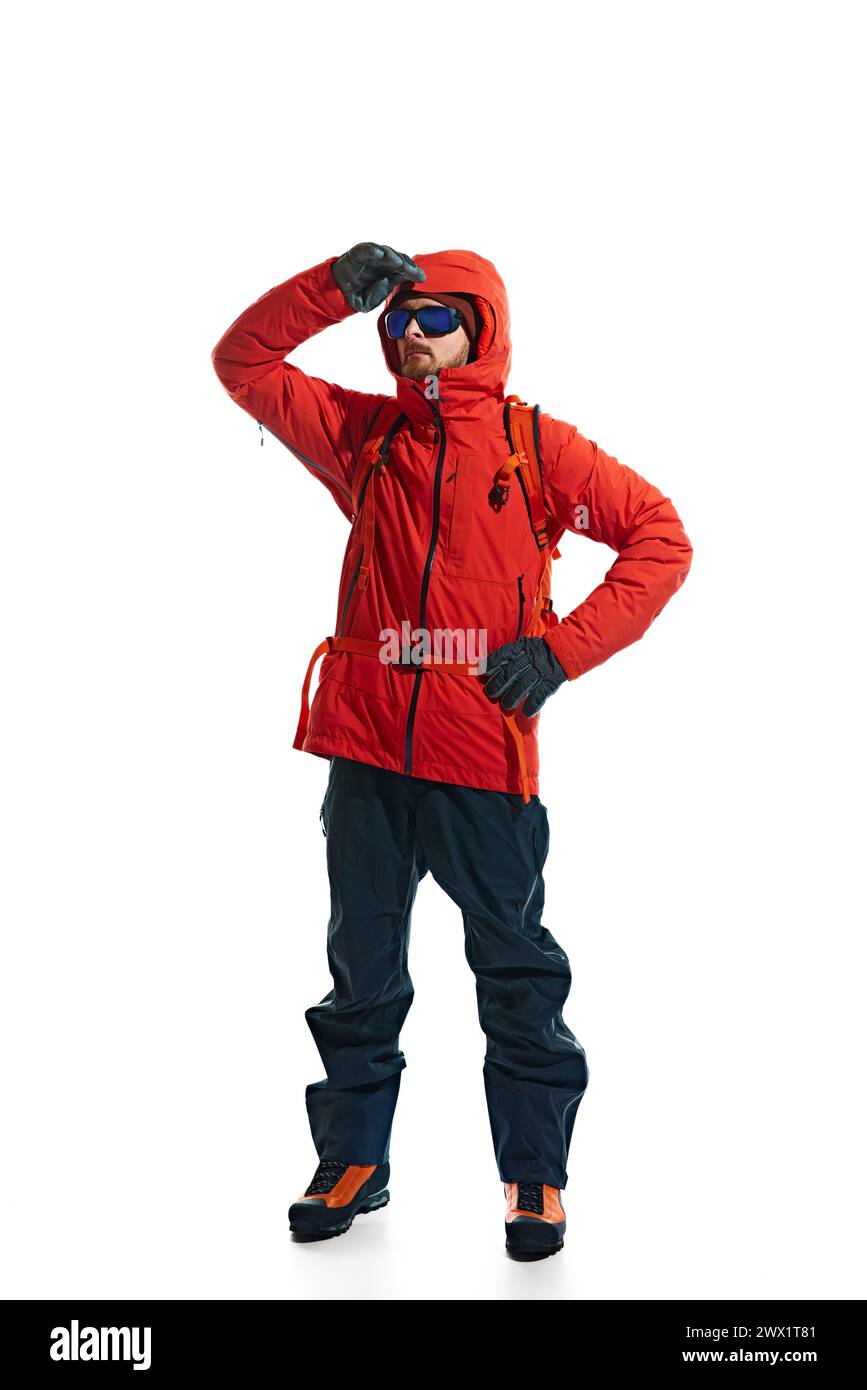 Male tourist wearing warm jacket, goggles and backpack for comfortable ...