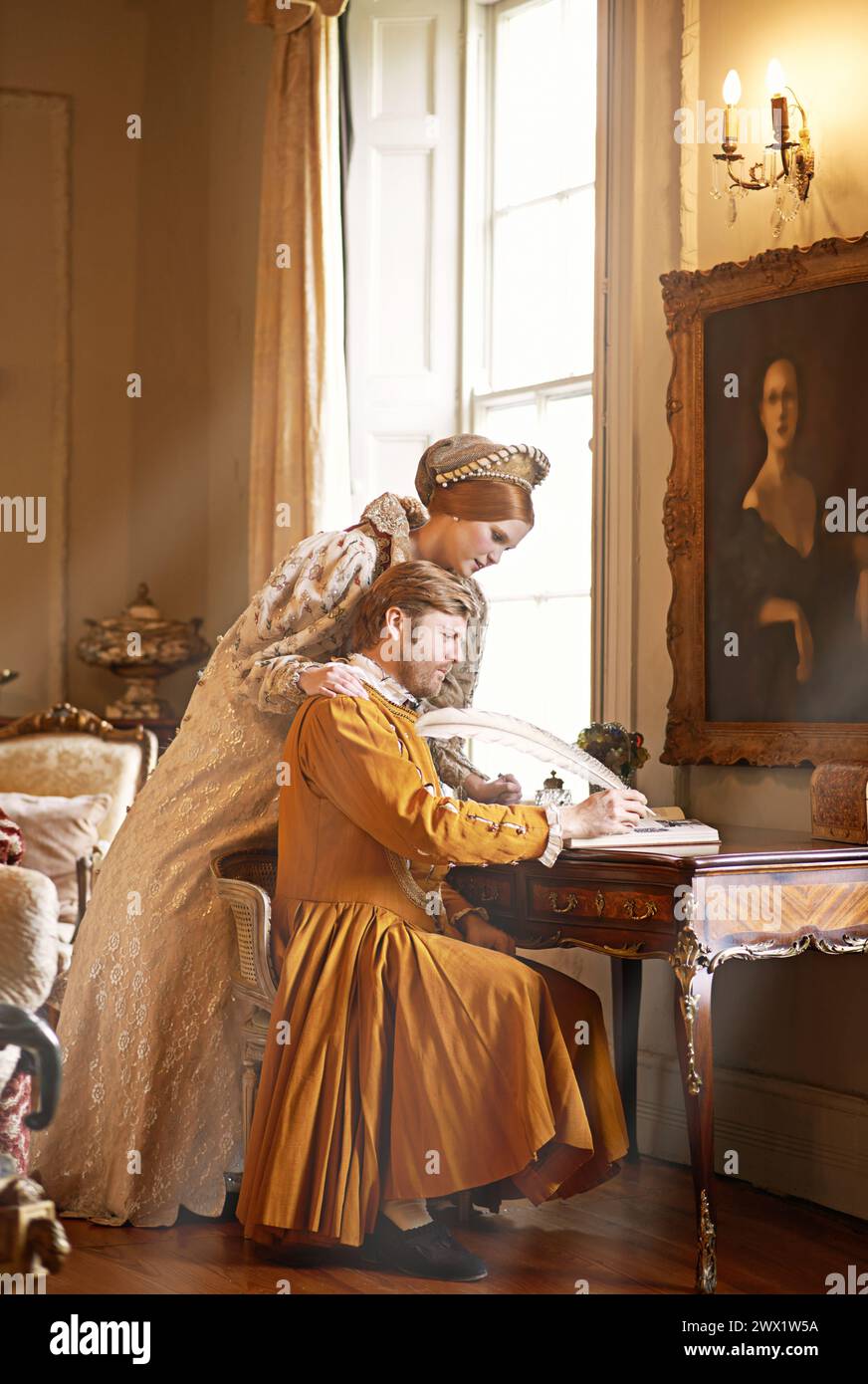 Couple, feather and writing a letter, renaissance and relax in home for ...