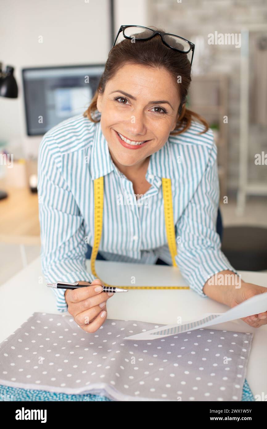 fashion designer woman working on her designs in the studio Stock Photo ...