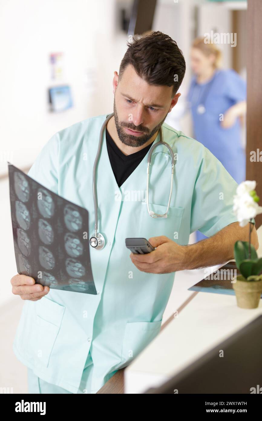 confused doctor looking at magnetic resonance imaging Stock Photo - Alamy