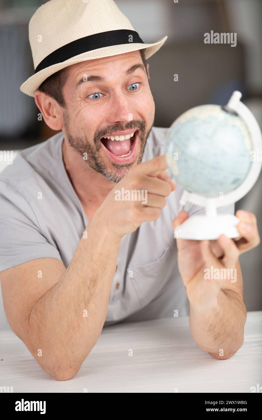 Man holds globe in hi-res stock photography and images - Alamy