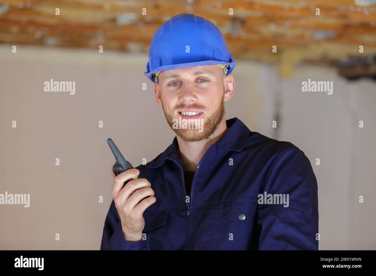 construction worker checking blueprint on site Stock Photo - Alamy