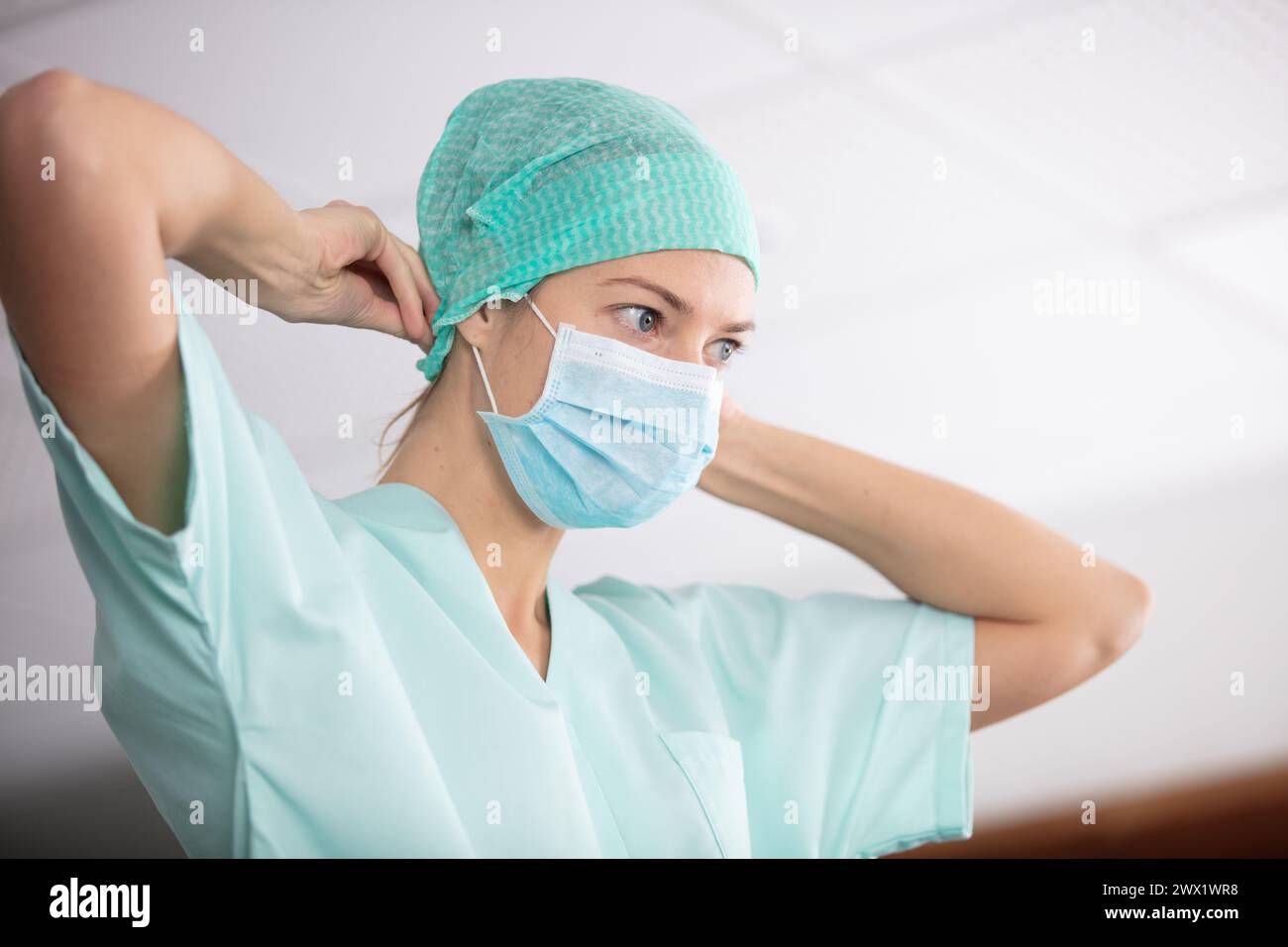 female nurse puts on a surgical mask Stock Photo - Alamy