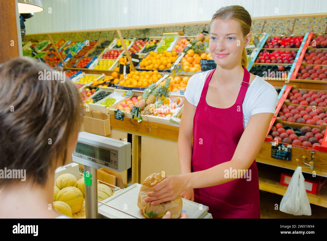 Woman holding bag putting peaches hi-res stock photography and images ...