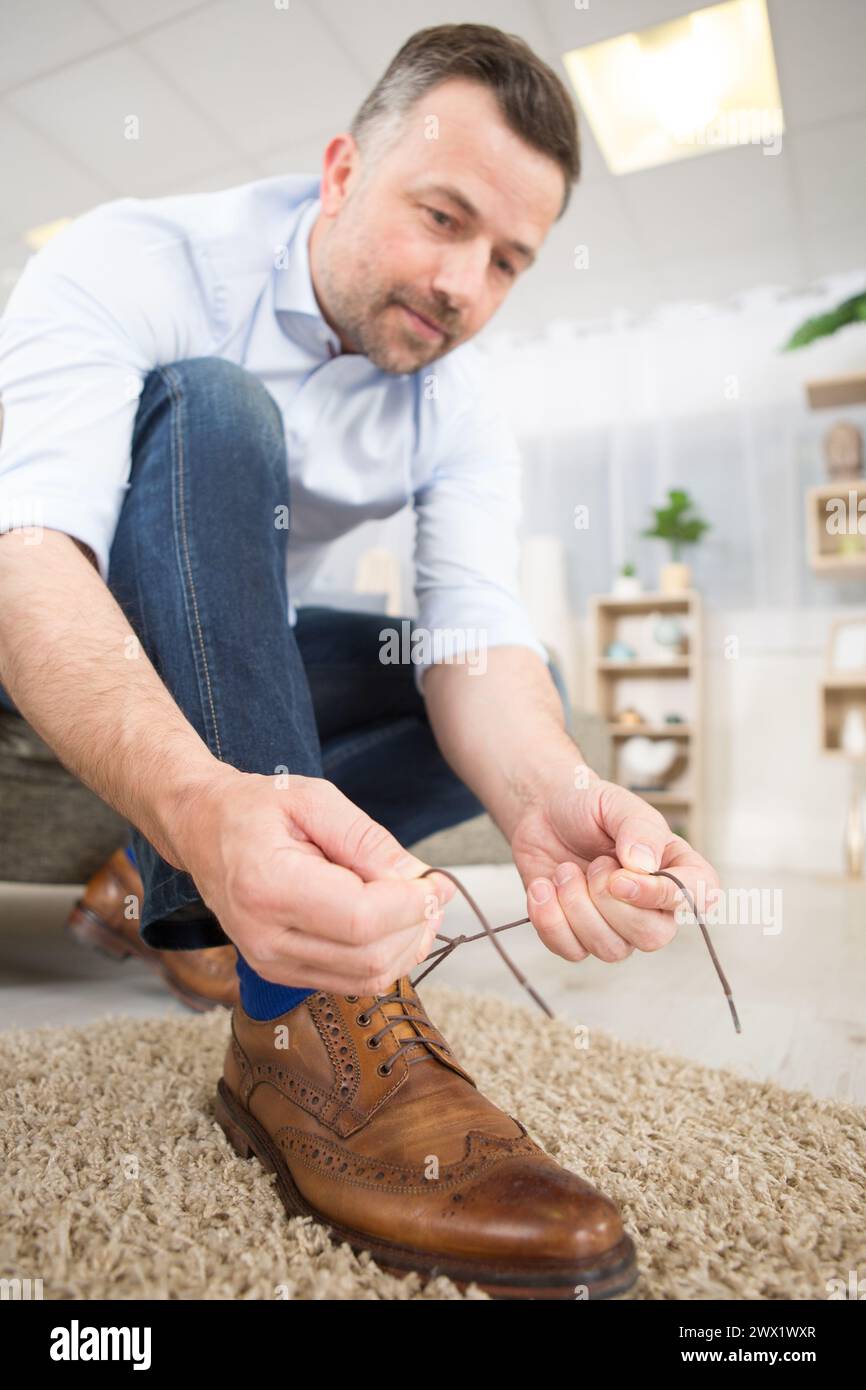 Boy tying his shoes hi-res stock photography and images - Alamy