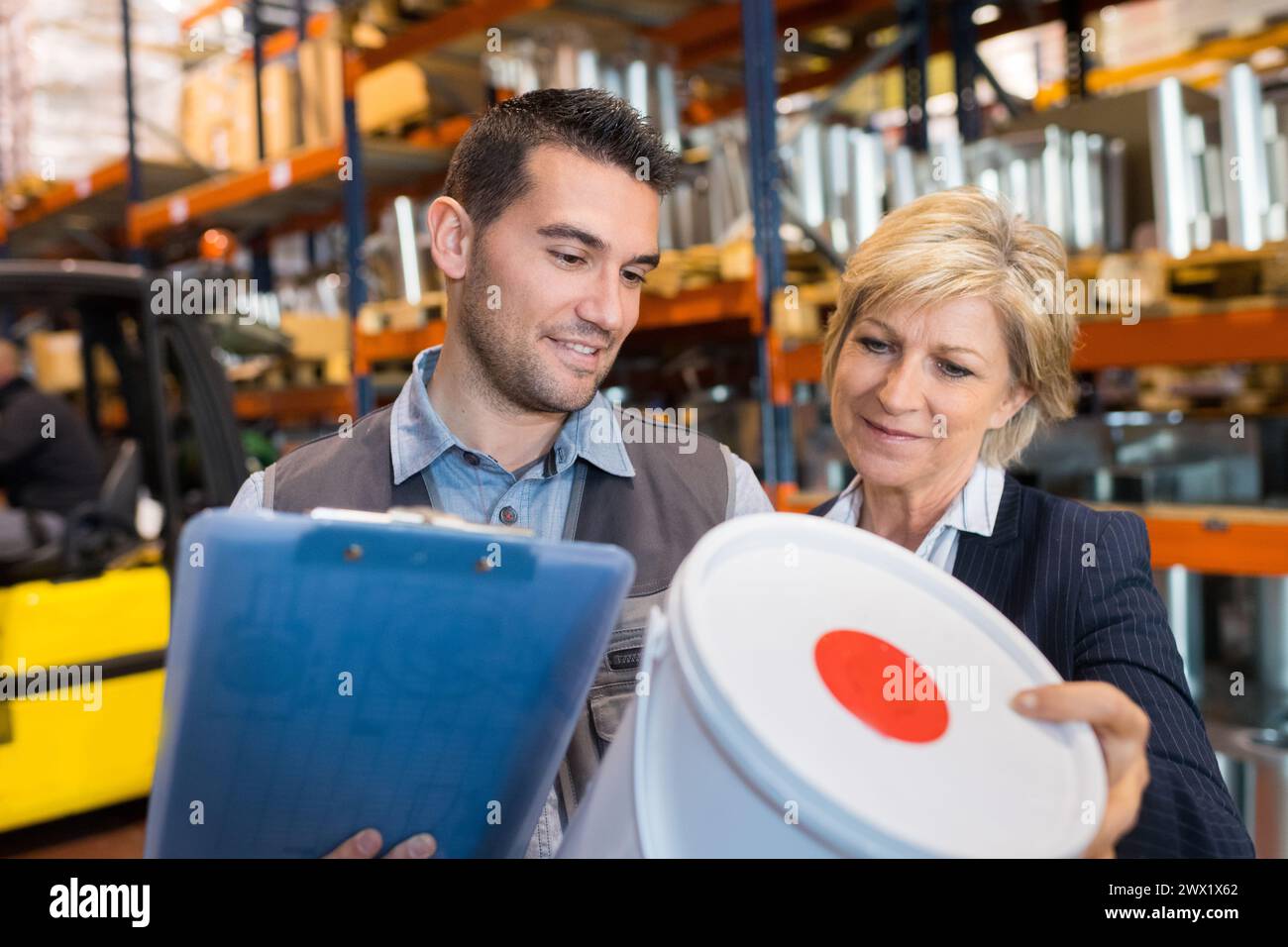 manager showing inventory worker the type of product Stock Photo - Alamy