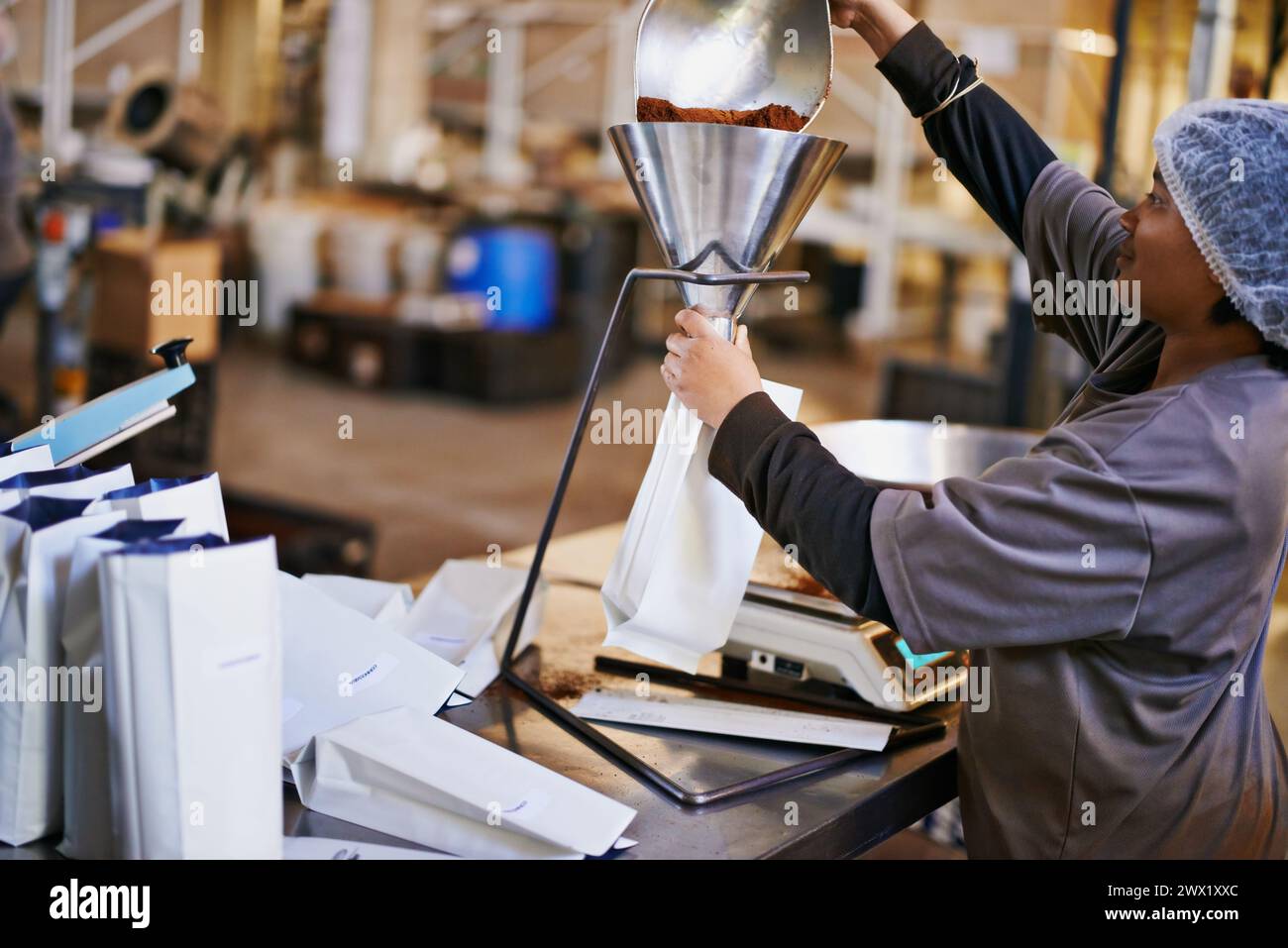 Business, worker and coffee packaging in factory with weighing tool ...