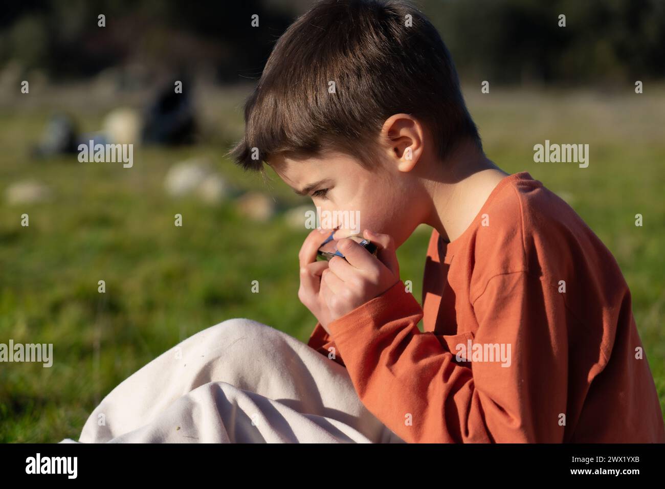 Boy playing harmonica hi-res stock photography and images - Alamy