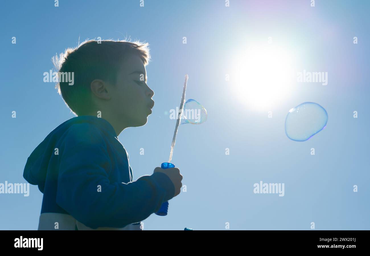 Boy blowing soap hi-res stock photography and images - Alamy