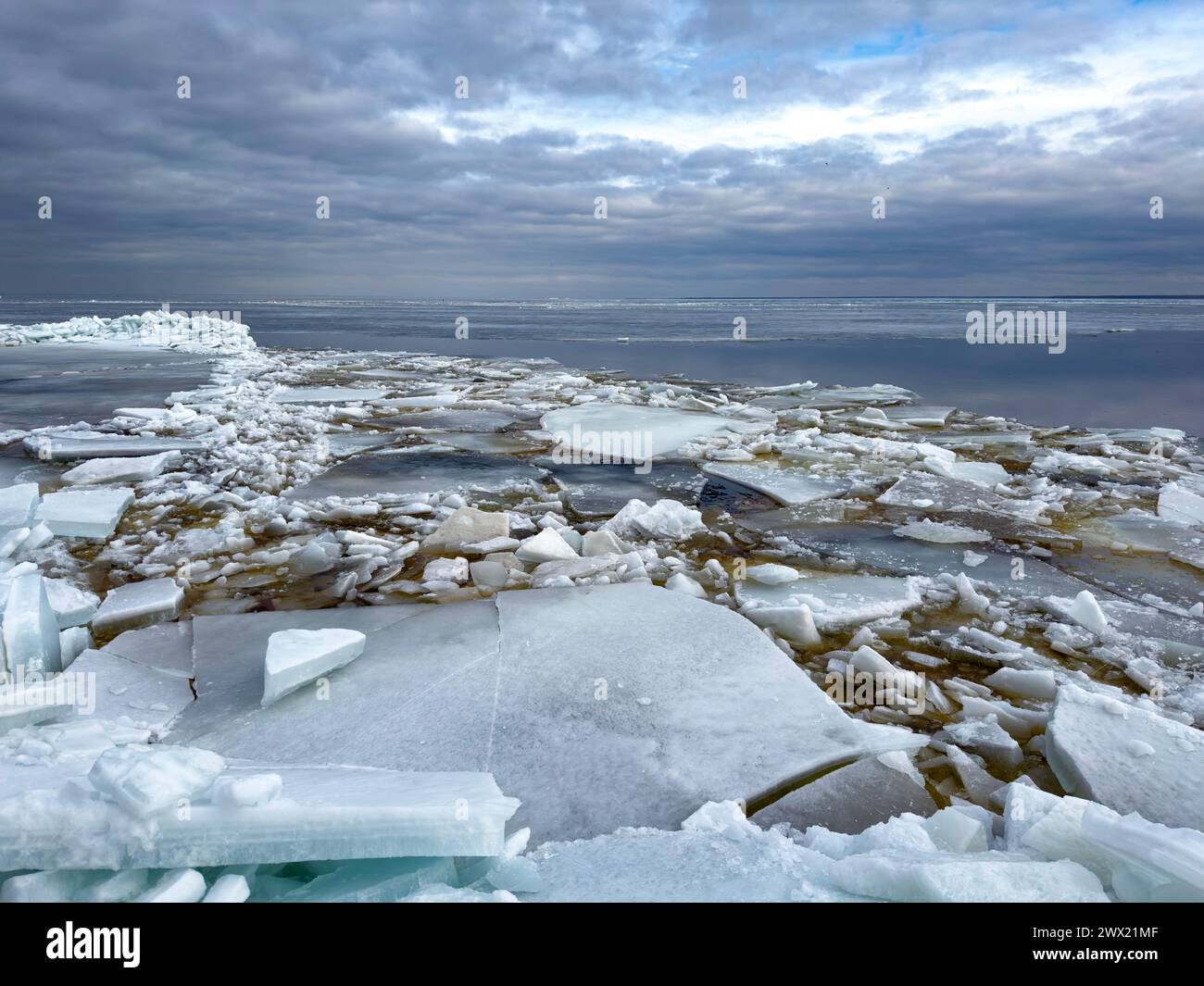 A dramatic expanse of broken ice sheets stretching to the horizon under ...
