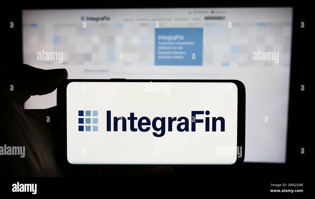 Person holding cellphone with logo of British financial company ...