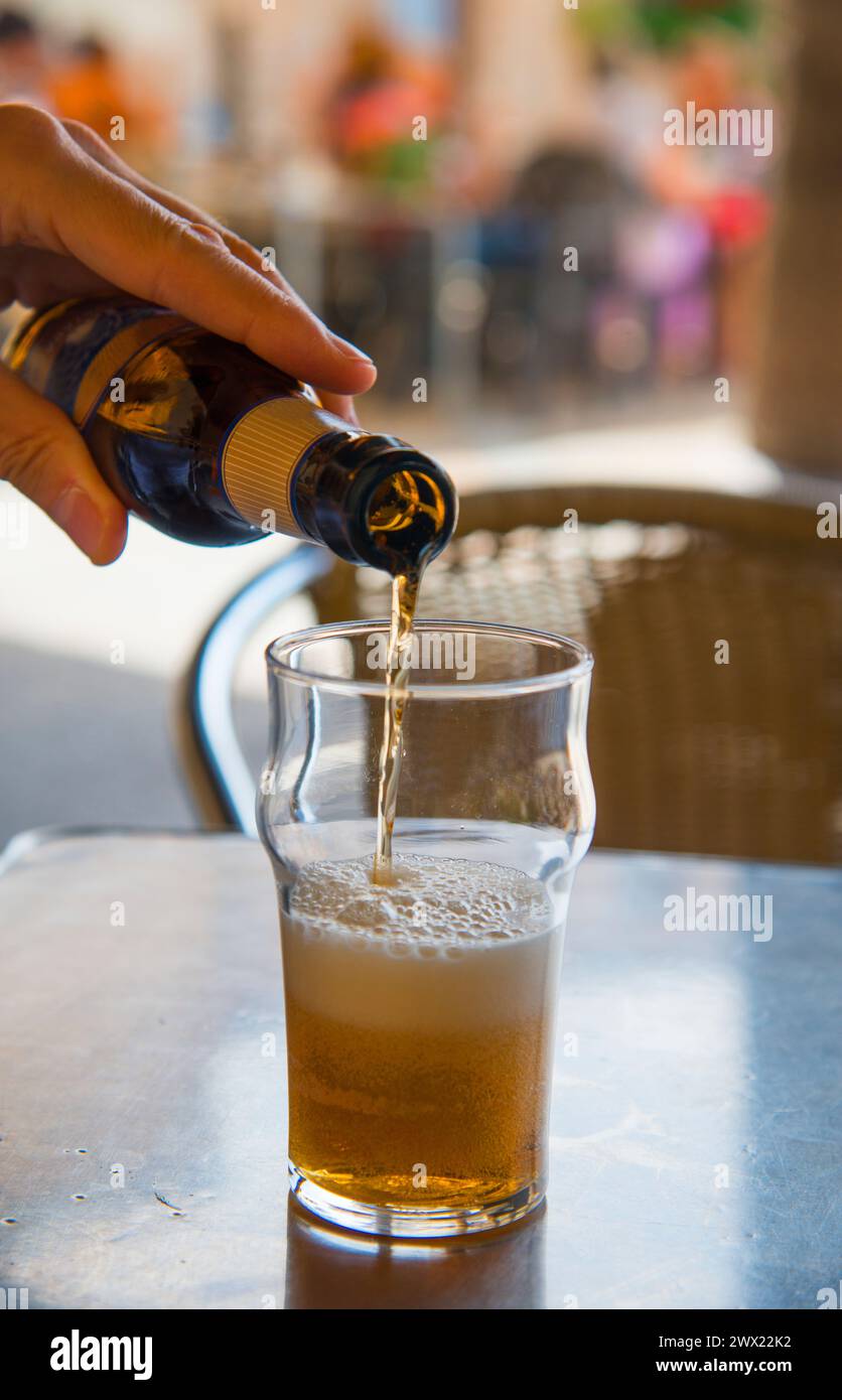 Pouring beer in a glass Stock Photo - Alamy