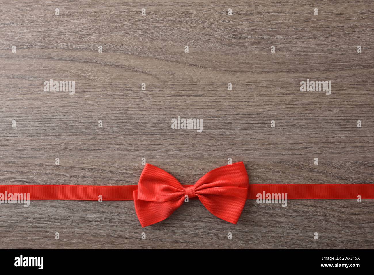Little red bow with ribbon at the bottom for event background ...