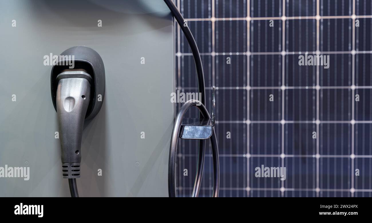 Close up of electric car charging station on the background of solar ...