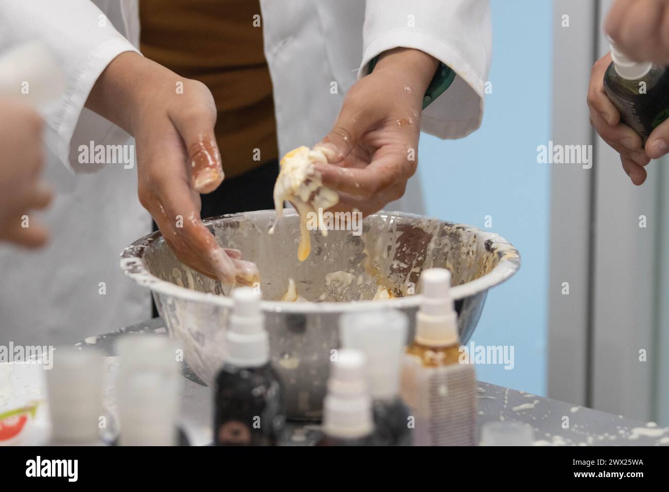 Child plays with food attempting a science experiment with adult ...