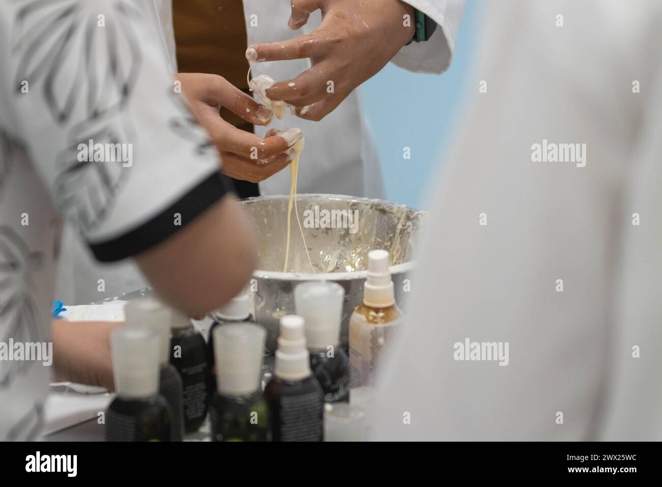 Child plays with food attempting a science experiment with adult ...