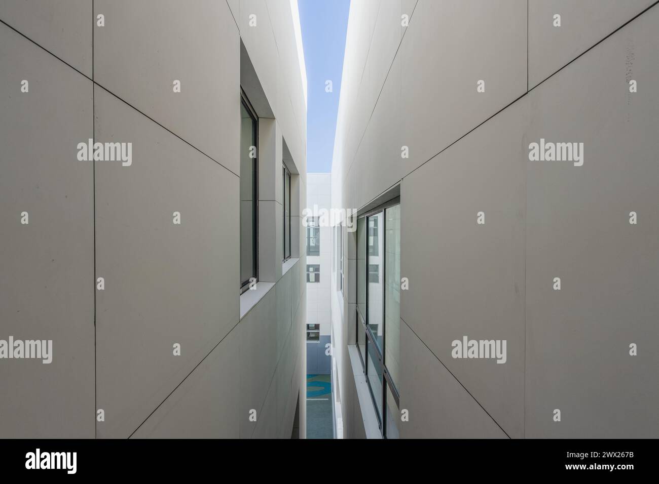 Narrow corridor in between to buildings overlooking an interior patio ...