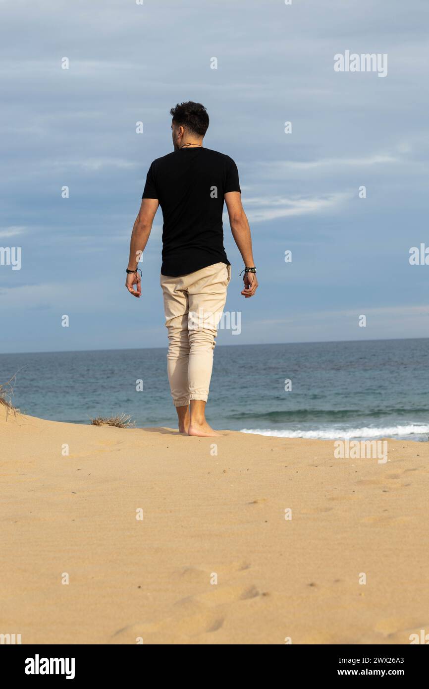 Barefoot man walking on the beach in the desert Stock Photo - Alamy