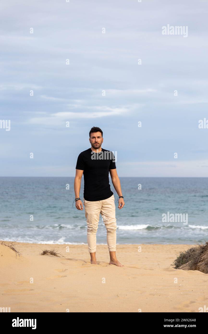 Barefoot man walking on the beach in the desert Stock Photo - Alamy